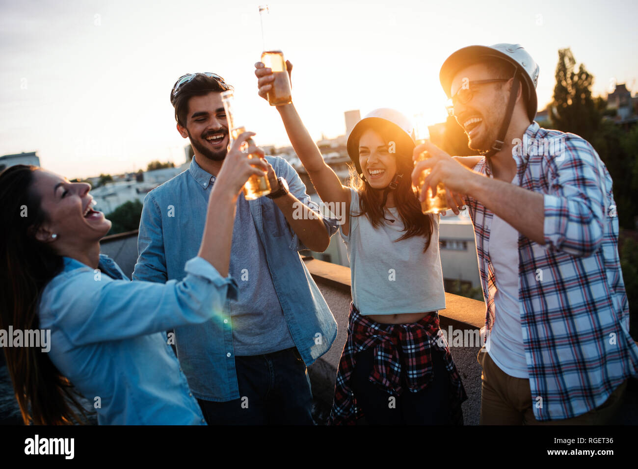 Group of happy friends having party on rooftop Stock Photo - Alamy