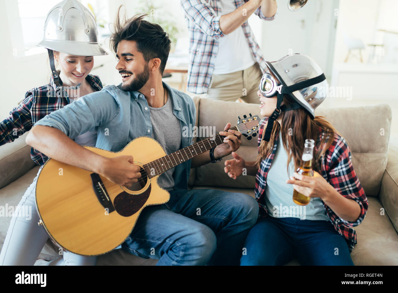 Friends having fun and partying in house and playing music Stock Photo ...
