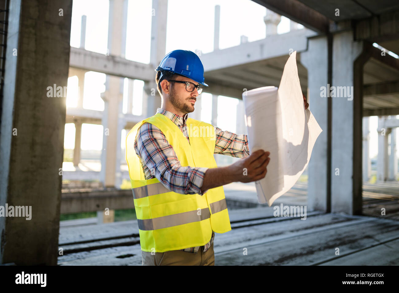 Picture of construction site engineer looking at plan Stock Photo - Alamy