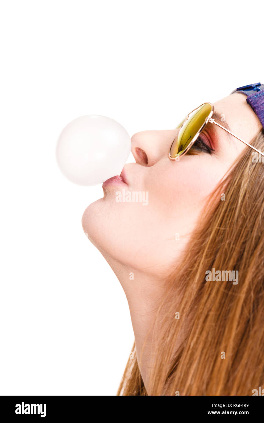 Woman casual style teen girl doing bubble with chewing gum face profile ...