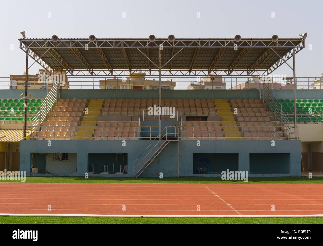 An empty middle tribune section with roof in public open stadium in ...