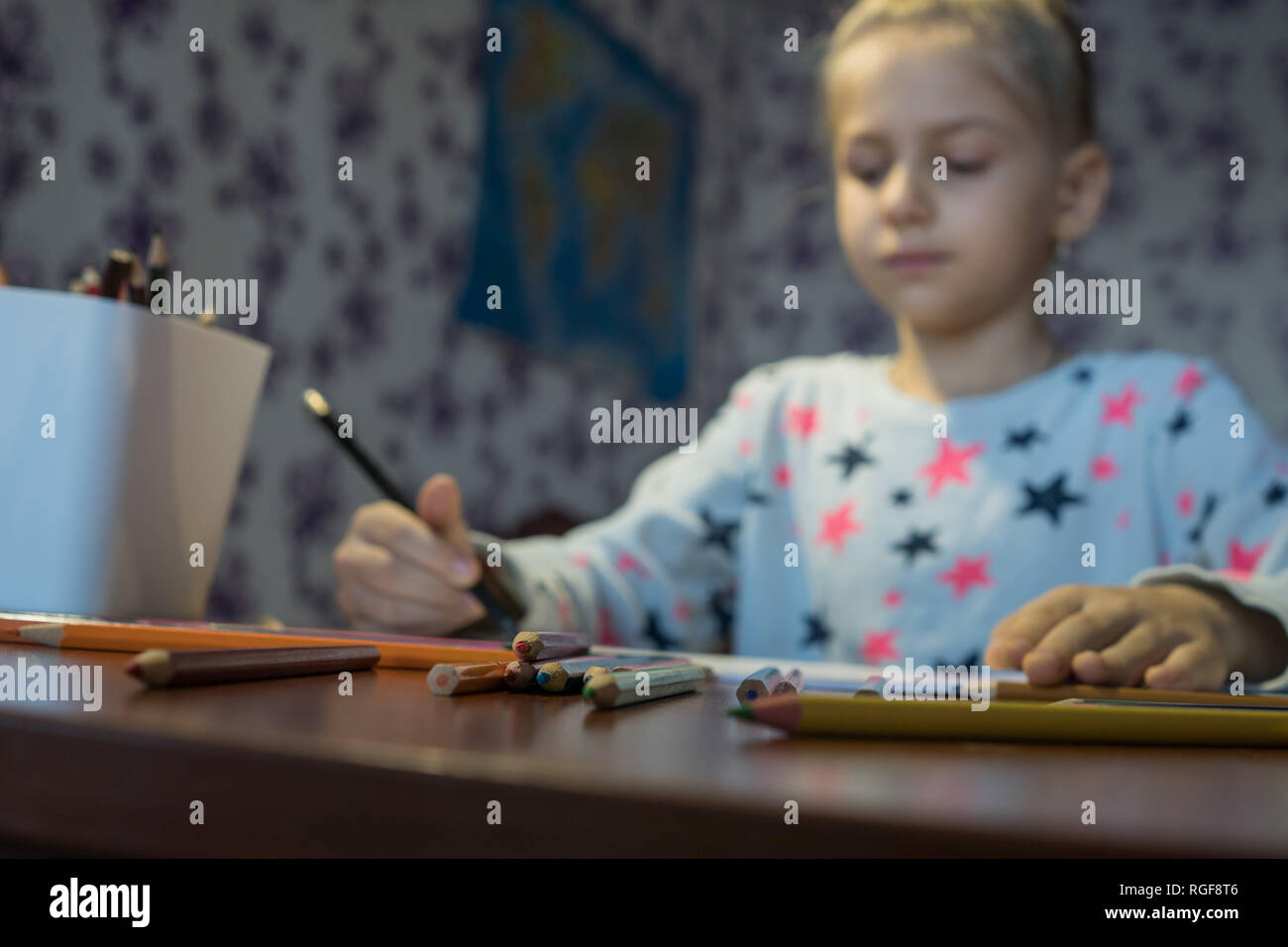 Little artist paints a picture with colored pencils Stock Photo - Alamy