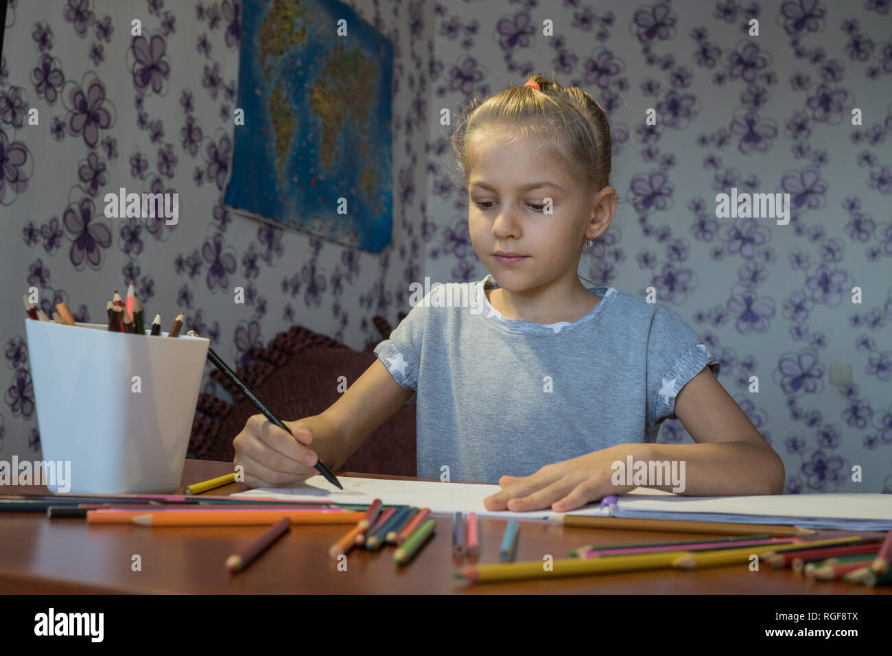 Little artist paints a picture with colored pencils Stock Photo - Alamy