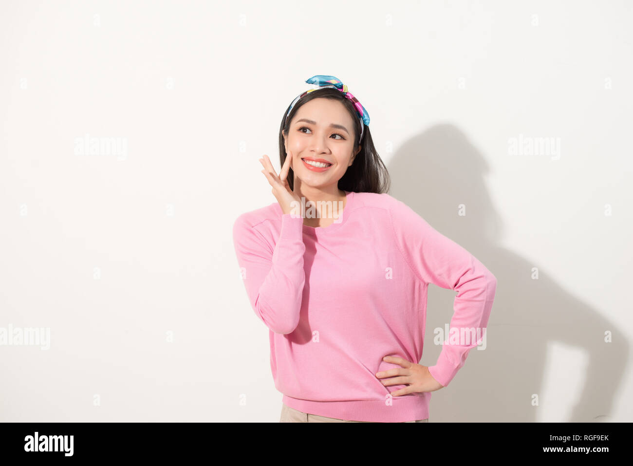 Asian woman touching her face with joy, nice smile, happy and bright ...
