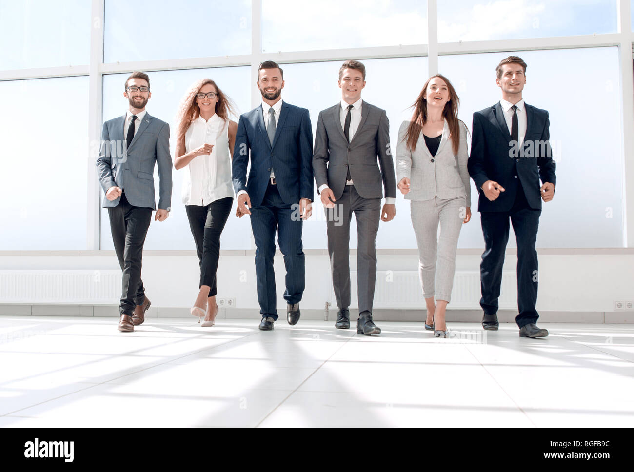 successful business walking in the office lobby Stock Photo - Alamy
