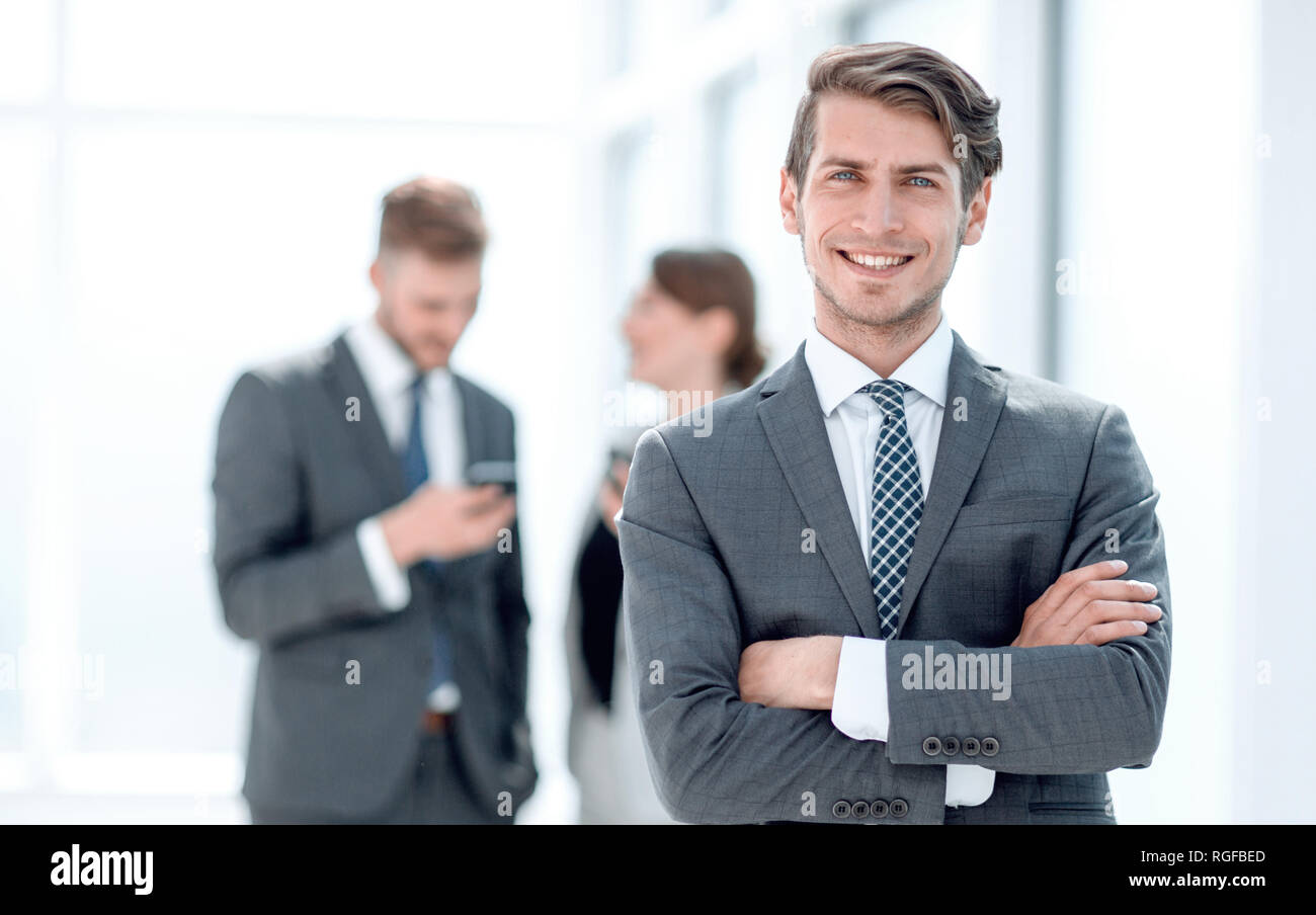 young successful businessman on background of office Stock Photo - Alamy