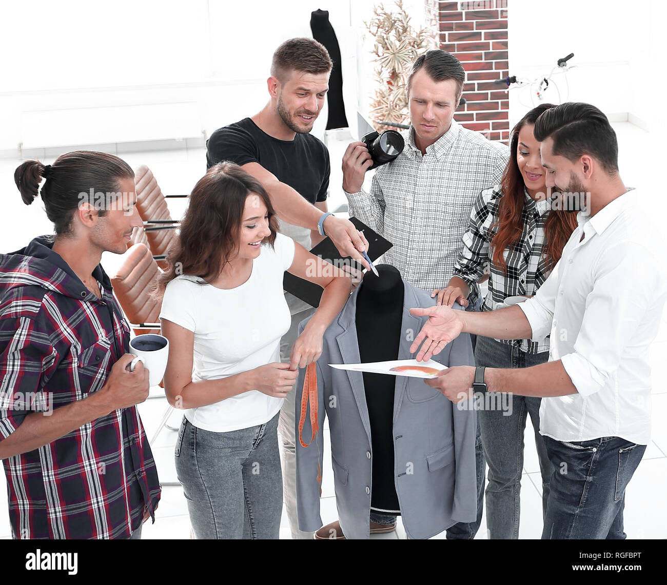 designers working with new models of men's clothing Stock Photo - Alamy