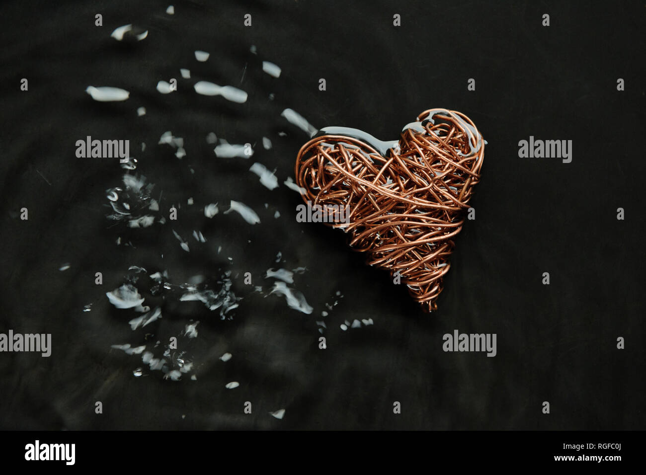 Copper wire heart made from reclaimed electric cable. Placed in water ...