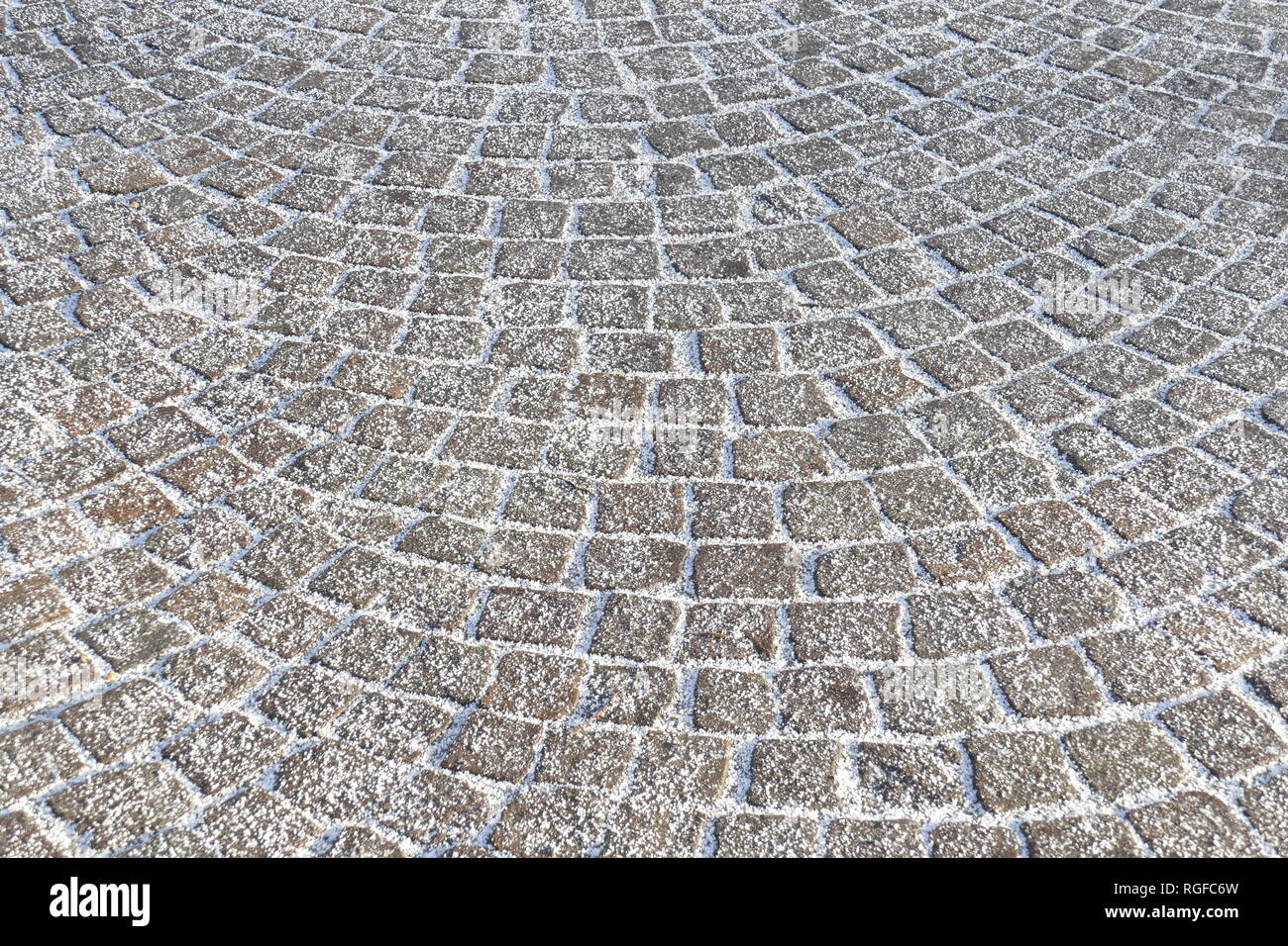 Cobblestone covered with snow grains Stock Photo - Alamy
