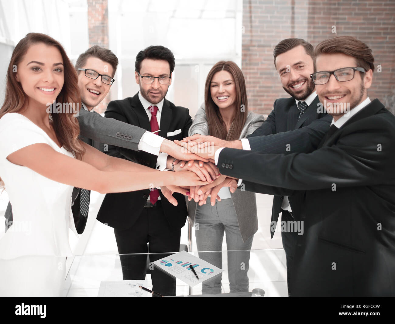 happy business team joining hands together Stock Photo - Alamy