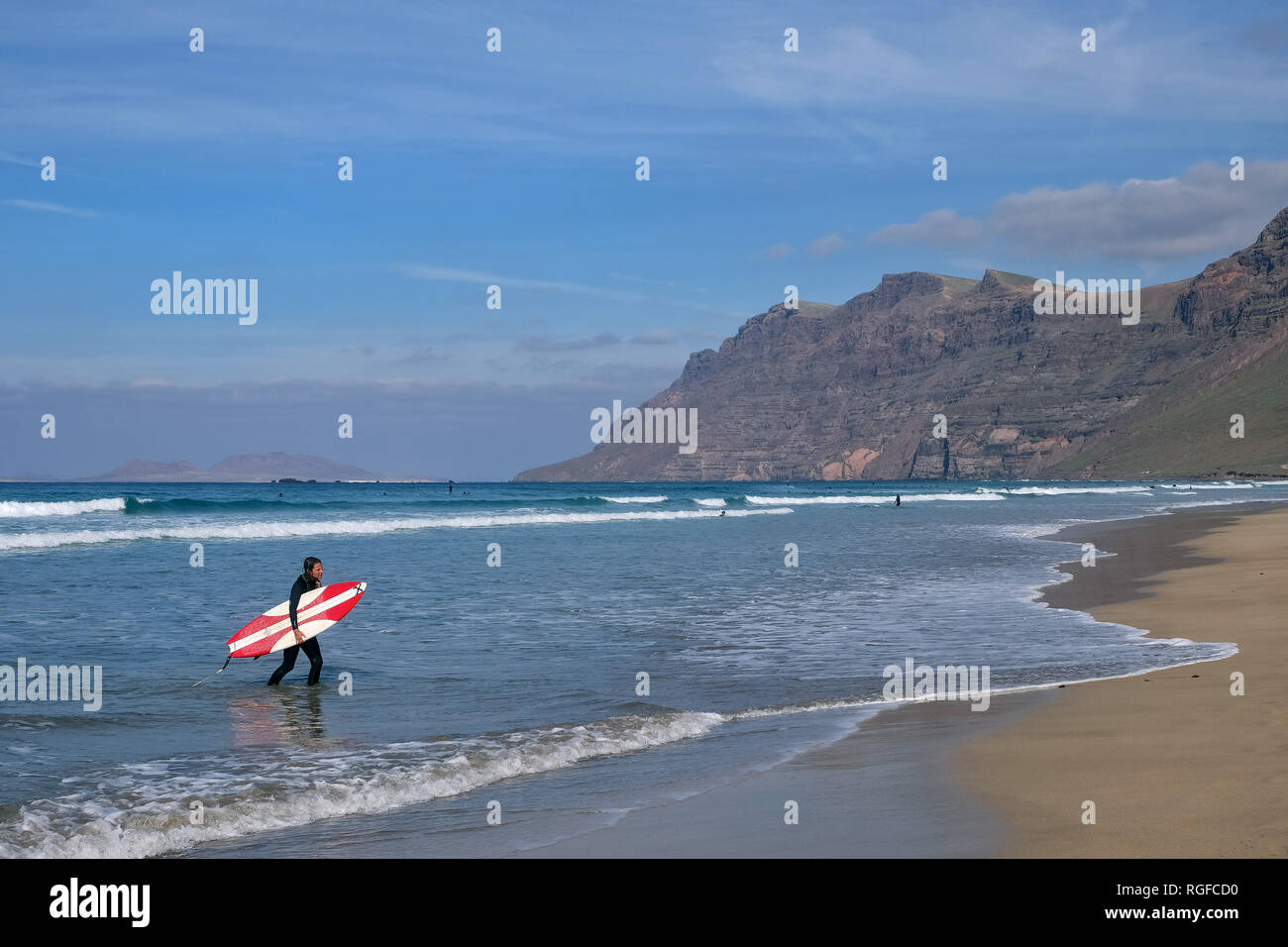 Surfer at Playa de Famara Stock Photo - Alamy