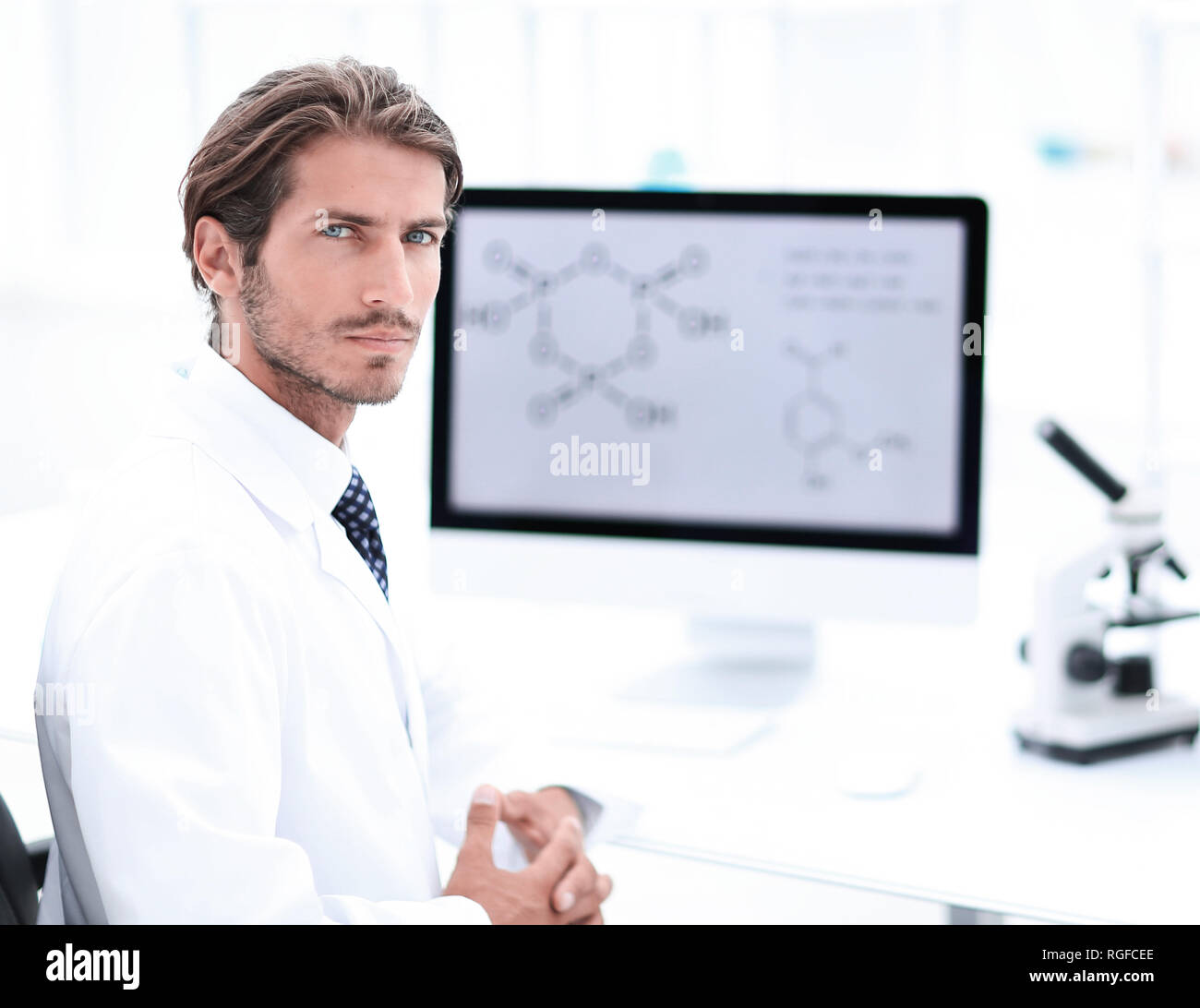 Portrait of a male scientist with a monitor looking at the camer Stock ...