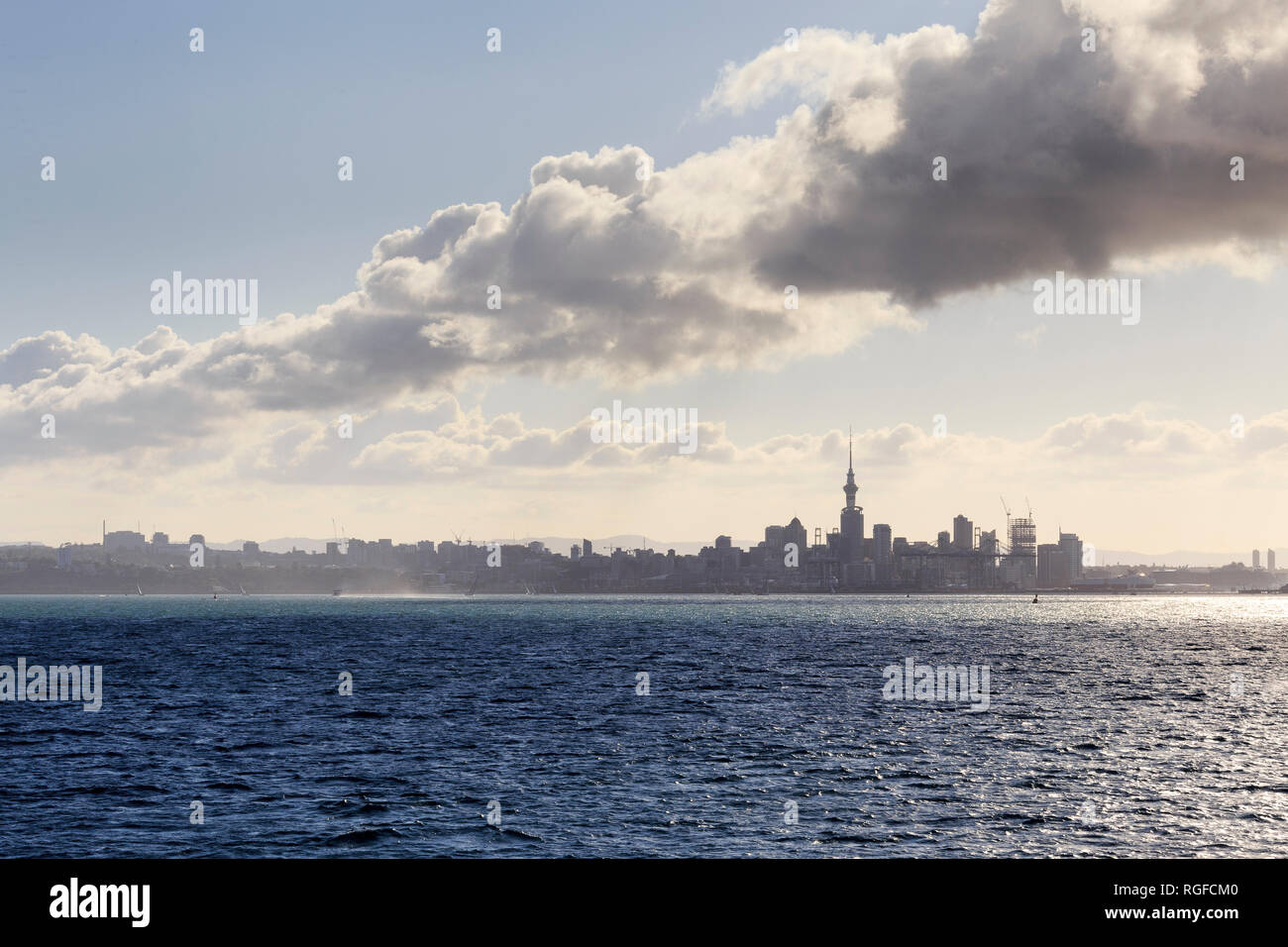 Misty outline of Auckland seen from the water, including Sky Tower ...
