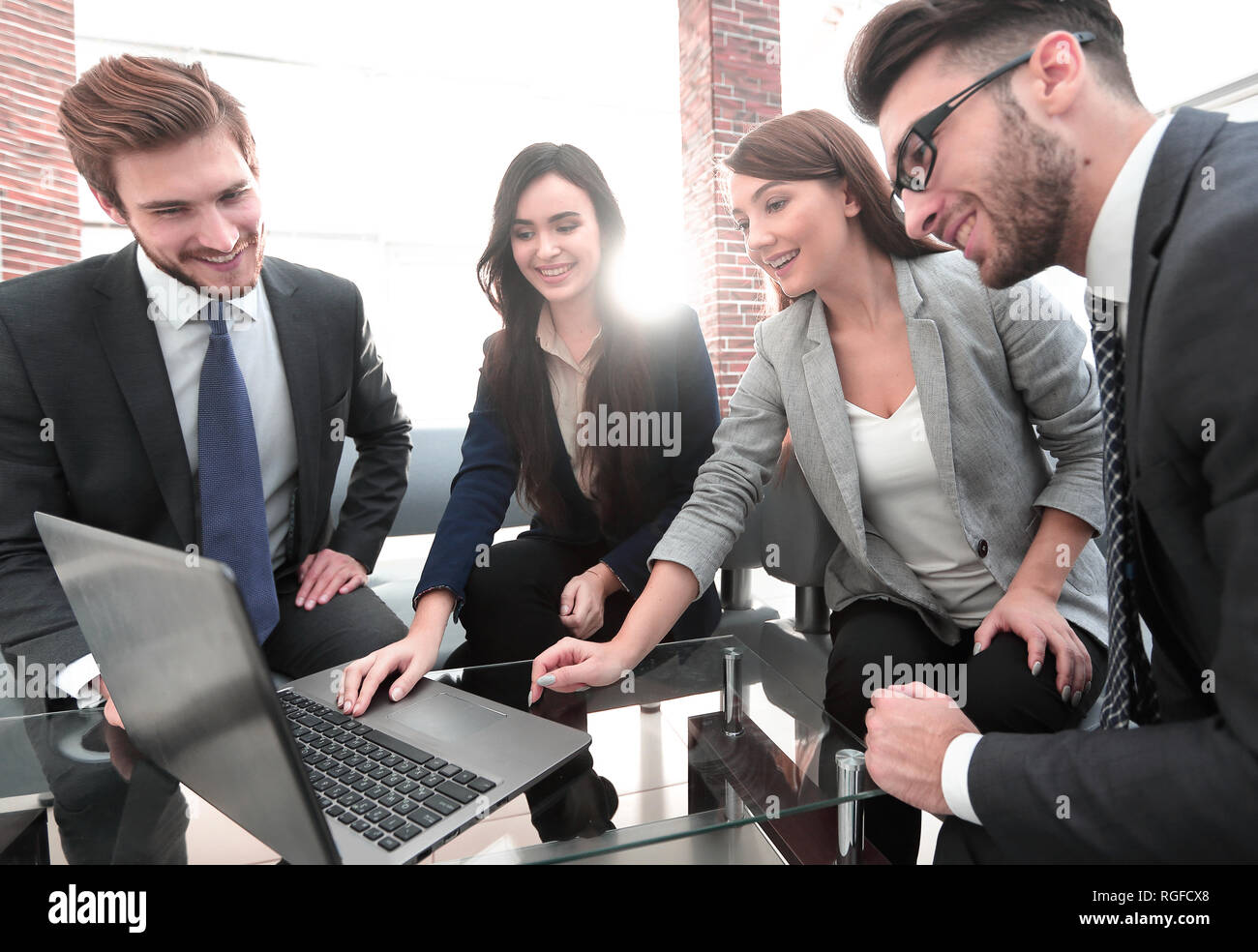 Concentrated business people use a laptop during a conference in Stock ...