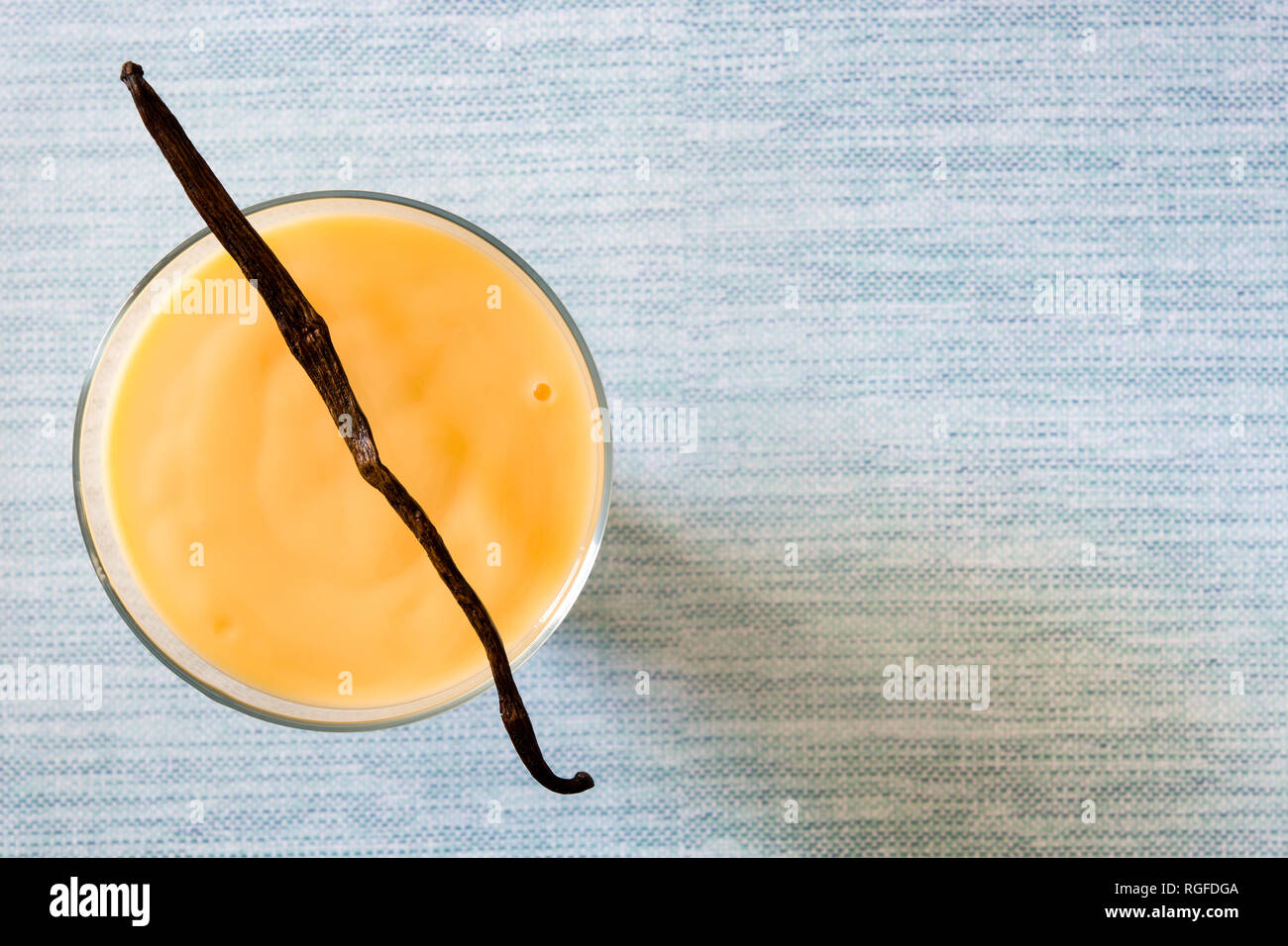 Bowl of homemade vanilla custard on blue background. Top view Stock ...