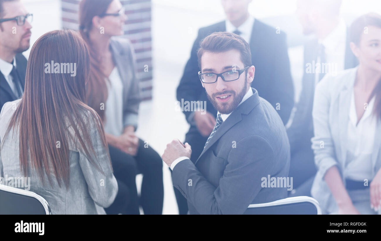 young employee sitting in a circle of colleagues Stock Photo - Alamy