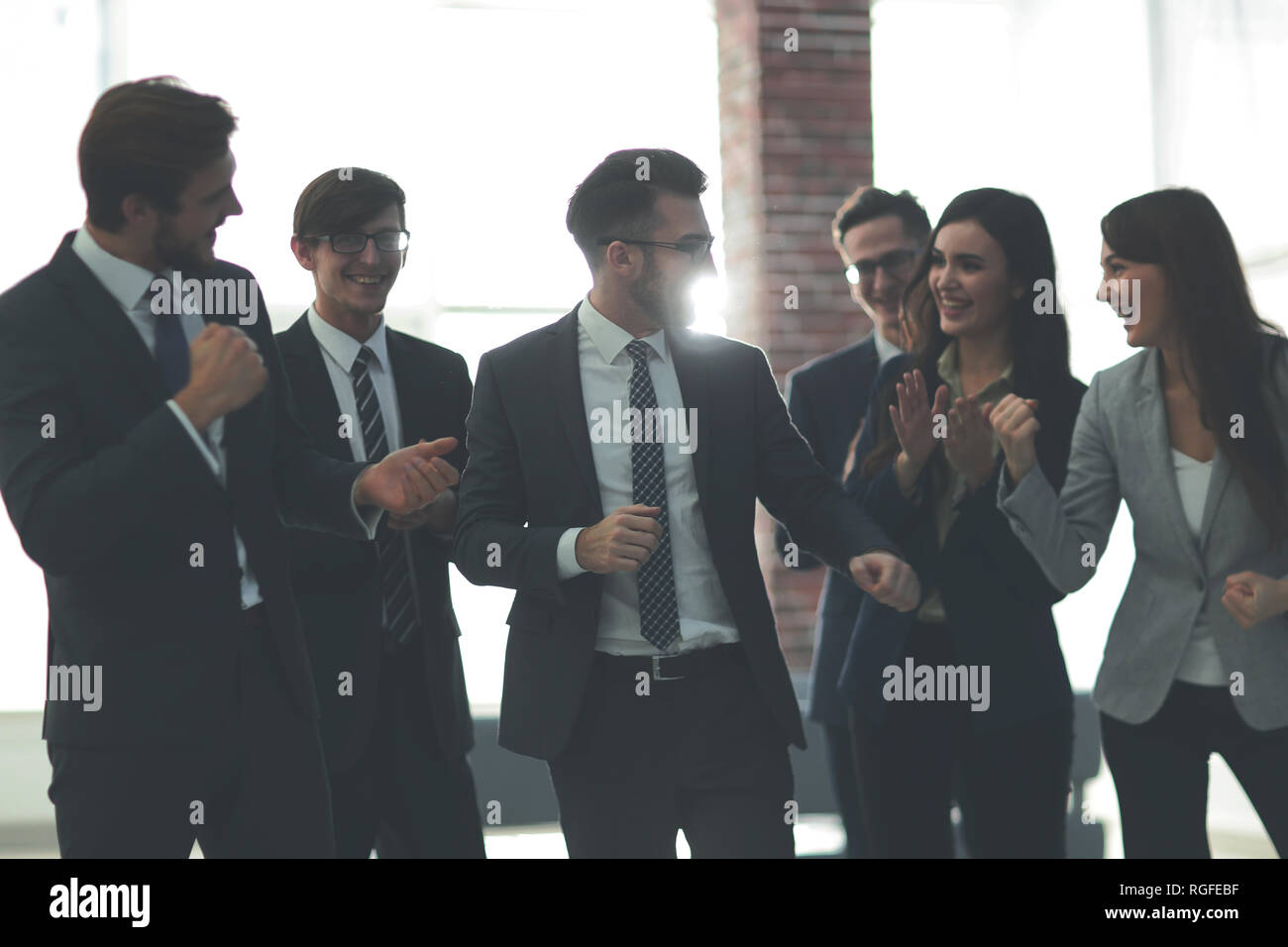 A team of business people congratulating each other Stock Photo - Alamy