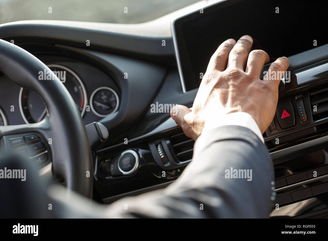Young mulatto businessman driver sitting inside the car using smart ...