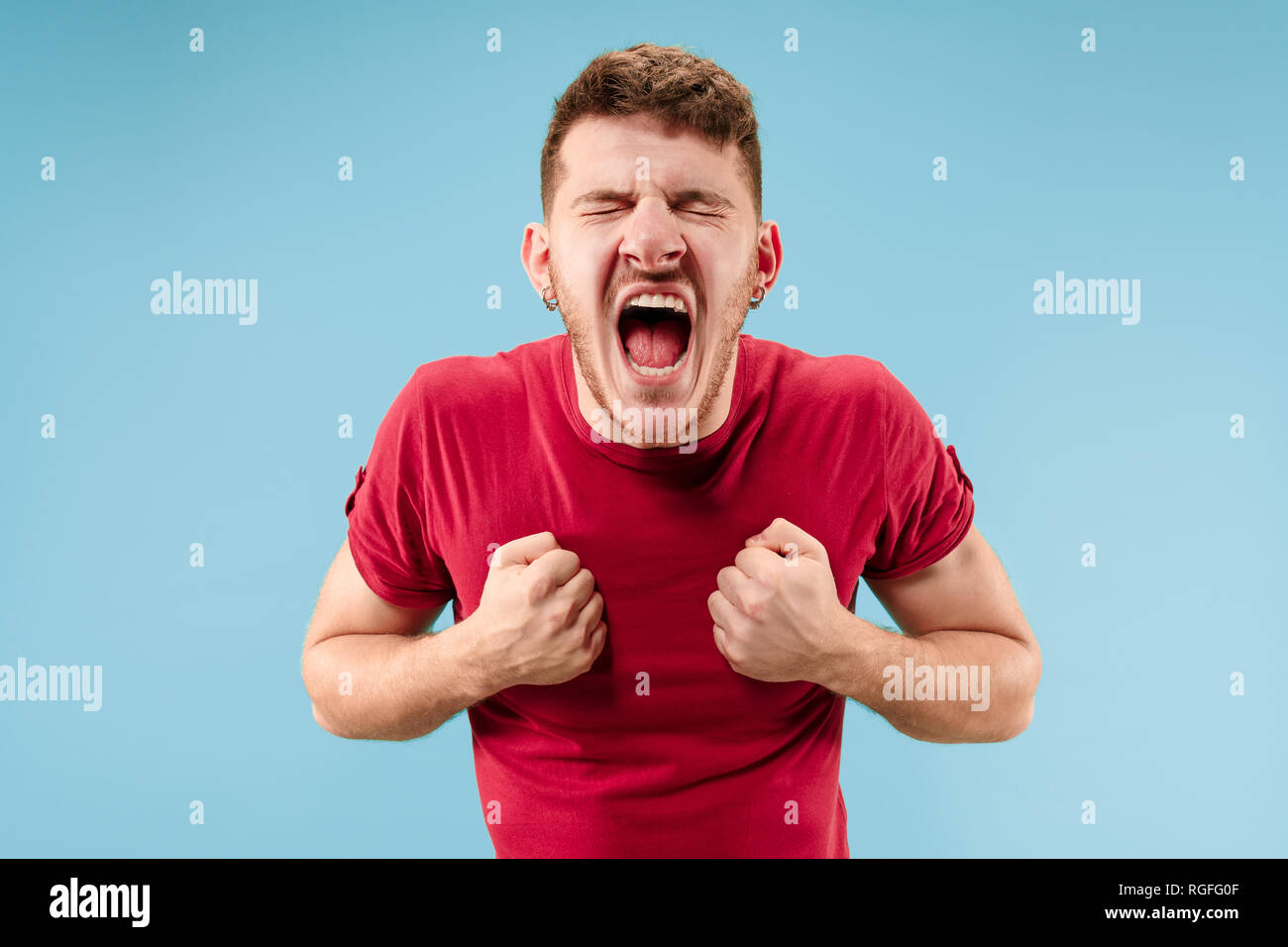 Screaming, hate, rage. Crying emotional angry man screaming on blue ...