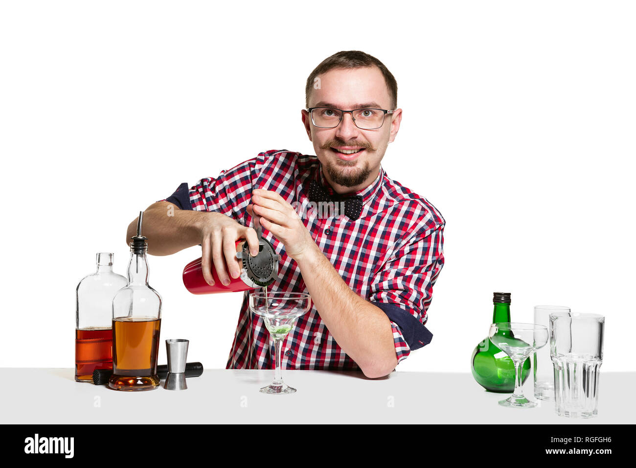 Expert male barman is making cocktail at studio isolated on white ...