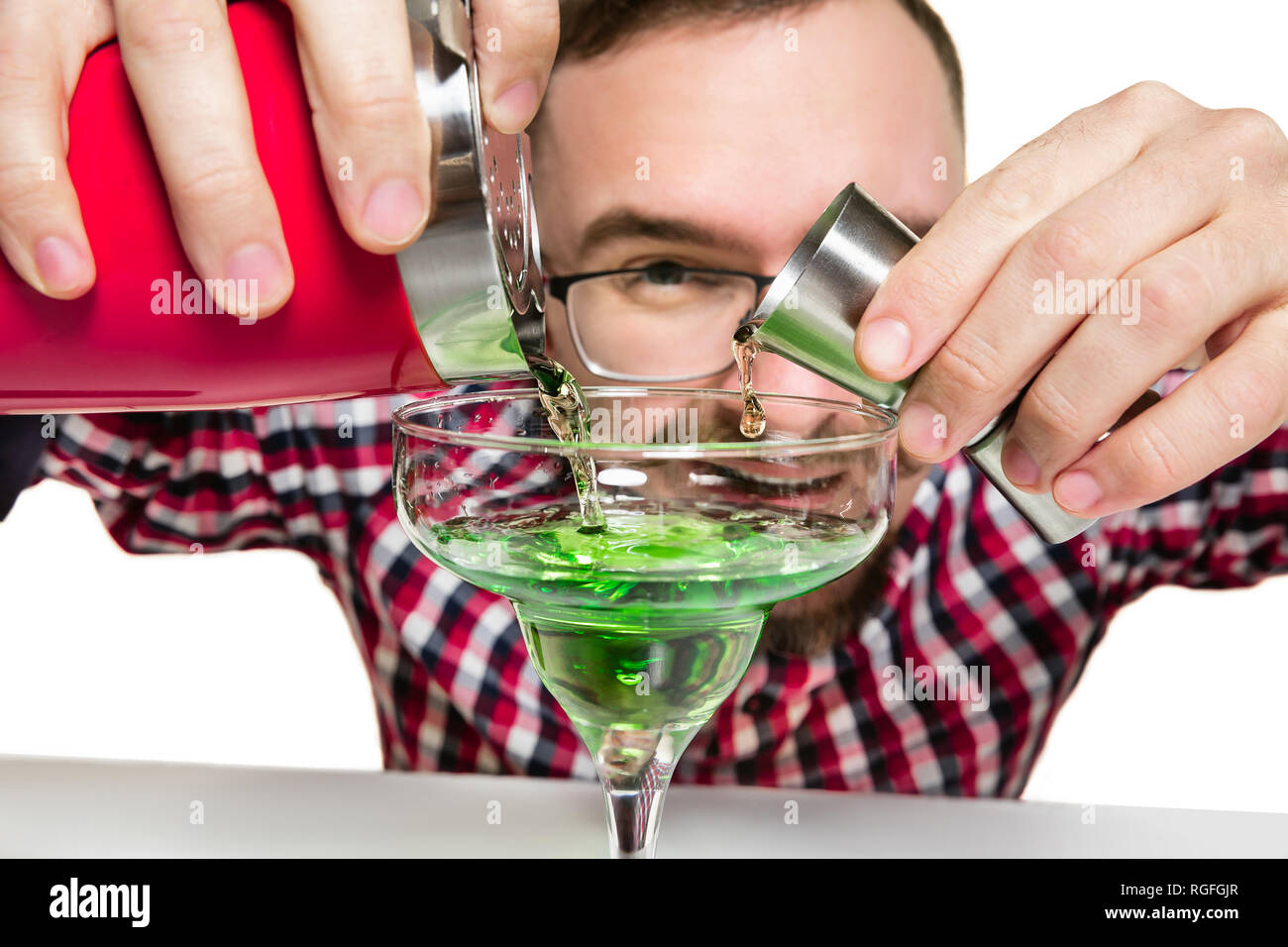 Expert male barman is making cocktail at studio isolated on white ...