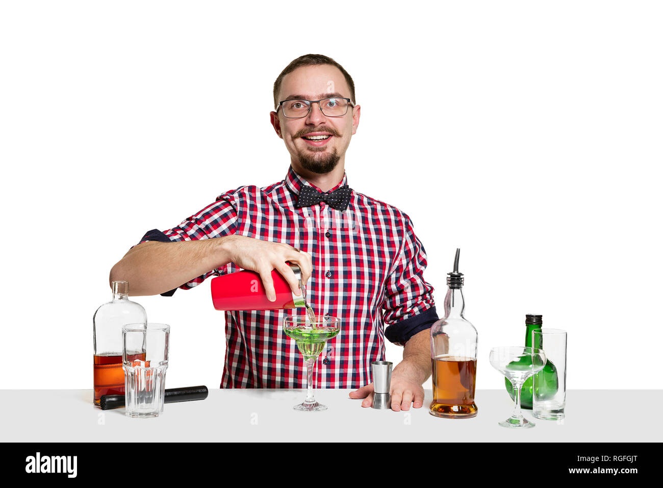 Expert male barman is making cocktail at studio isolated on white ...