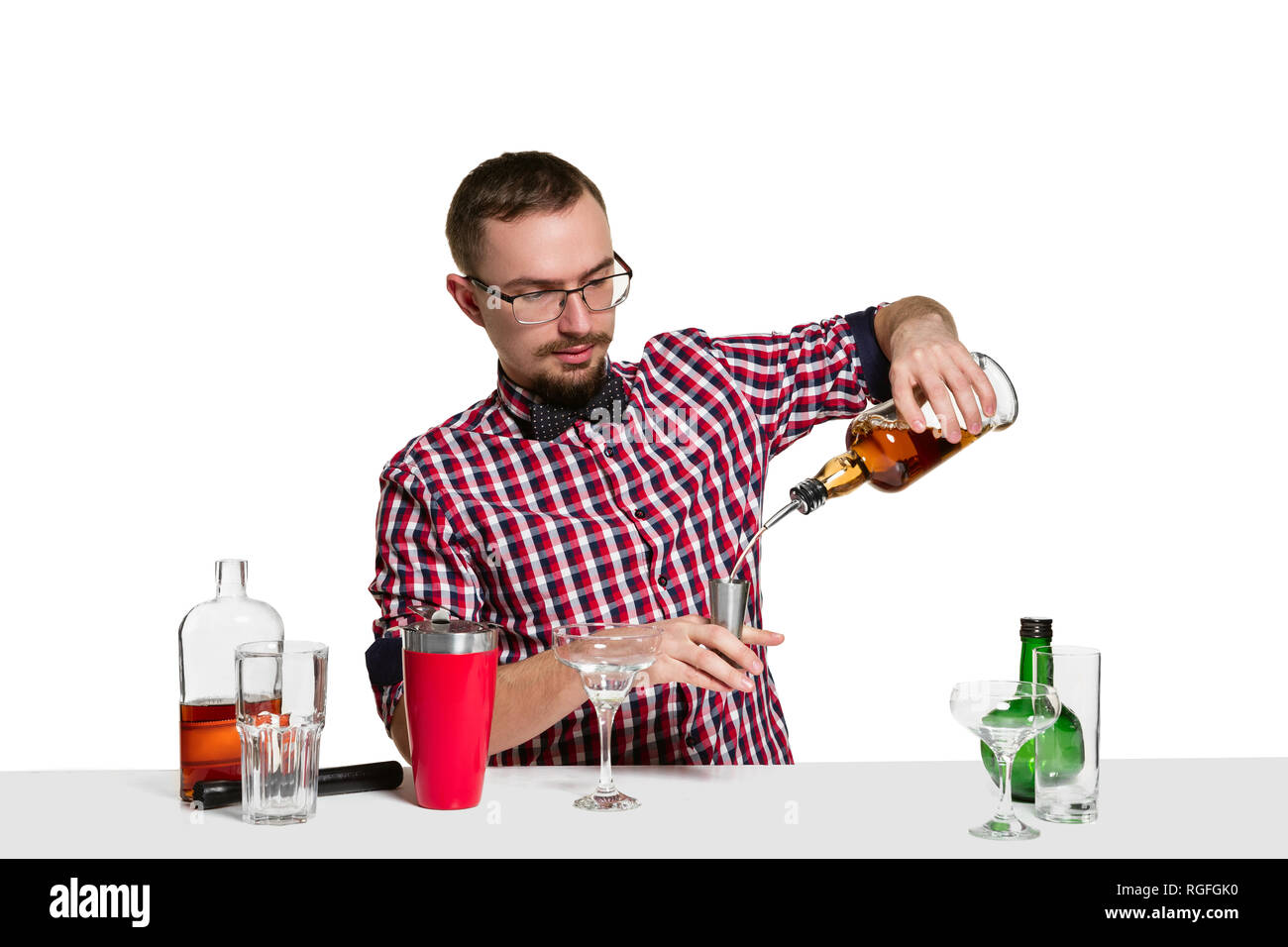 Expert male barman is making cocktail at studio isolated on white ...