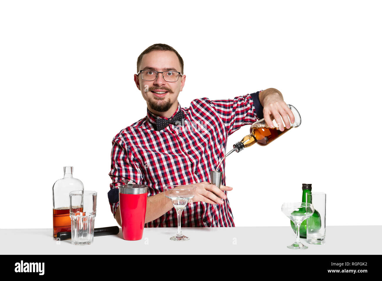 Expert male barman is making cocktail at studio isolated on white ...