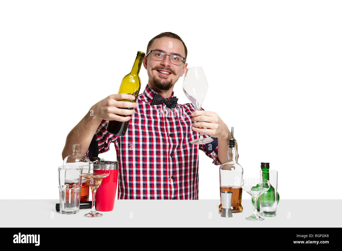 Expert male barman is making cocktail at studio isolated on white ...