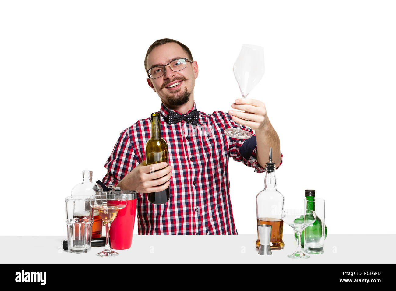 Expert male barman is making cocktail at studio isolated on white ...