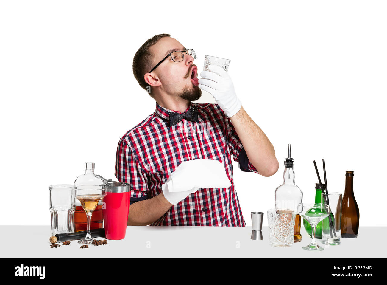 Expert male barman is making cocktail at studio isolated on white ...
