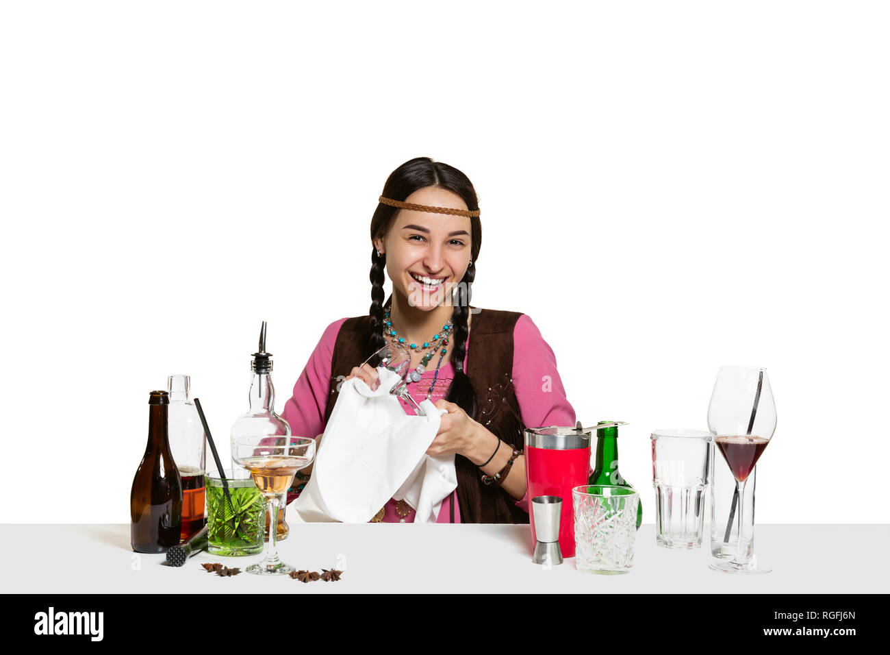 Expert female barman is making cocktail at studio isolated on white ...