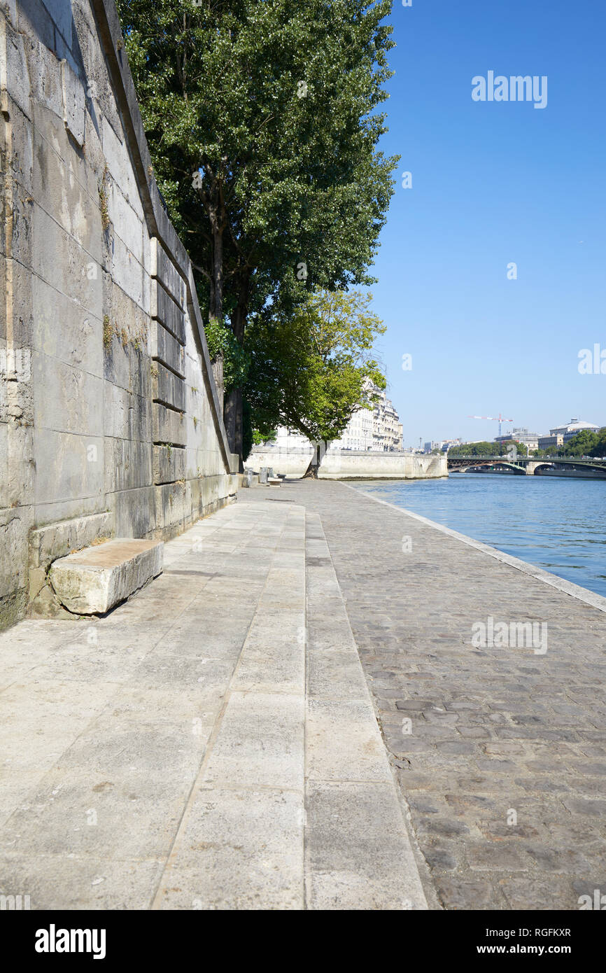 Paris, empty Seine river docks with steps in a sunny summer day in ...