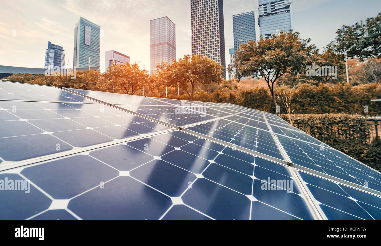 Ecological energy renewable solar panel plant with urban landscape ...