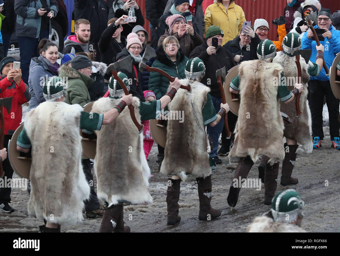Crowds cheer on the Jarl Squad as they march through Lerwick as snow ...