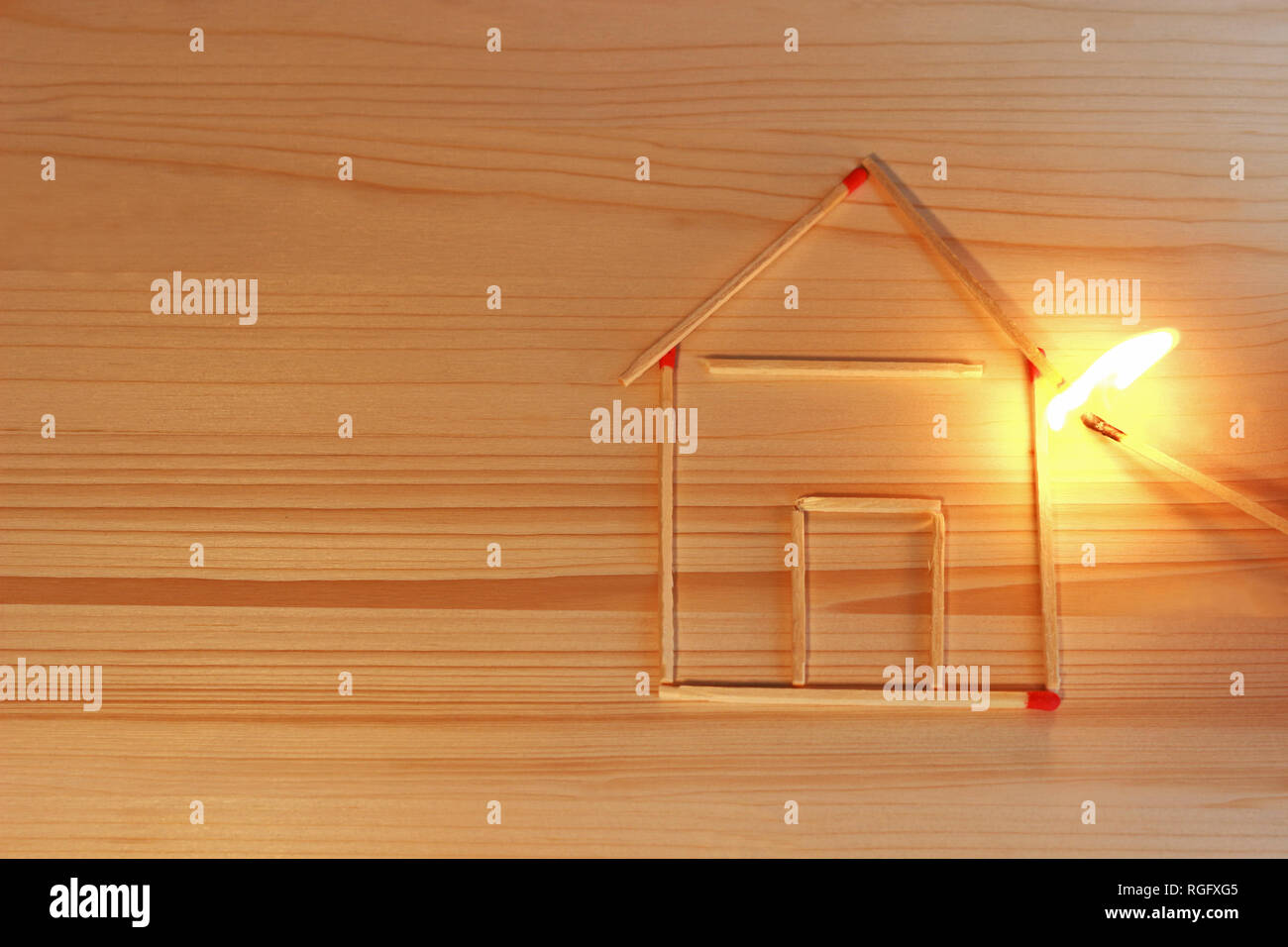 house laid with matches catching fire, arson, someone holding a burning ...