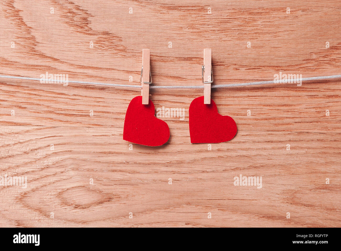 row of red paper hearts on clothespins on wooden background Stock Photo ...