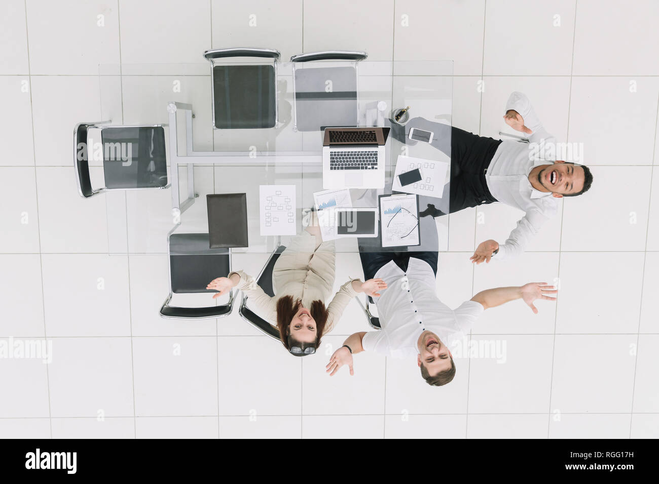 top view. happy employees sitting at the office Desk Stock Photo - Alamy