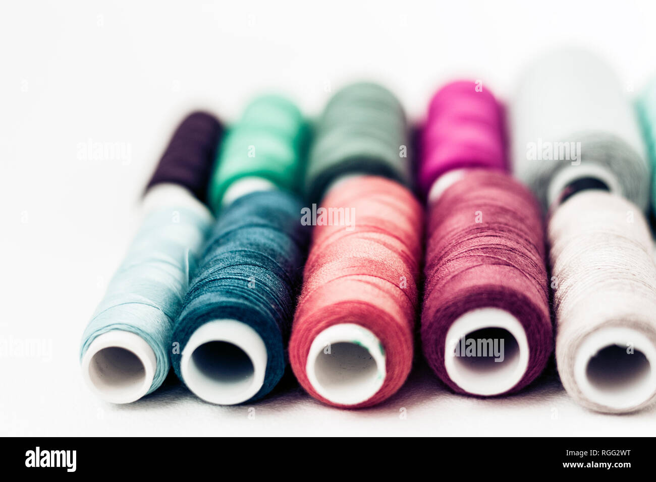 Colored sewing thread coils on white background with copy space for ...