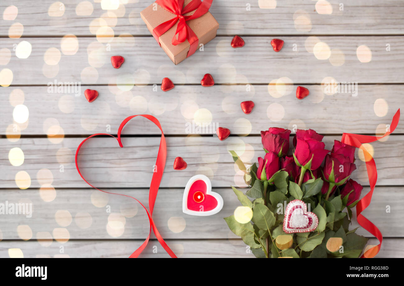 close up of red roses, gift, candies and candle Stock Photo - Alamy