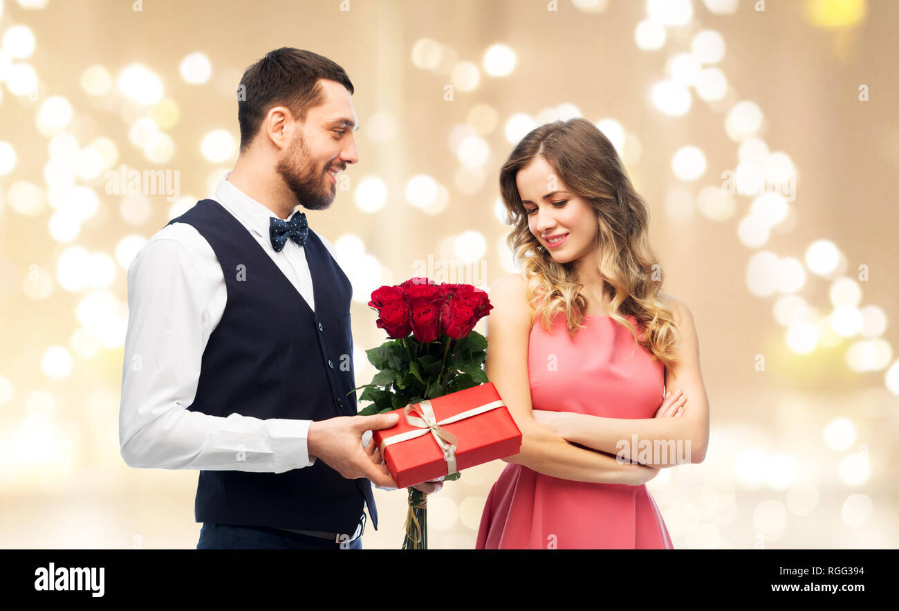 happy man giving woman flowers and present Stock Photo - Alamy