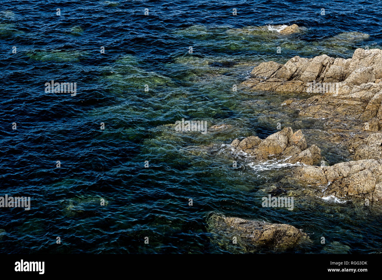 Coastal detail of granite rocks and blue sea Stock Photo - Alamy