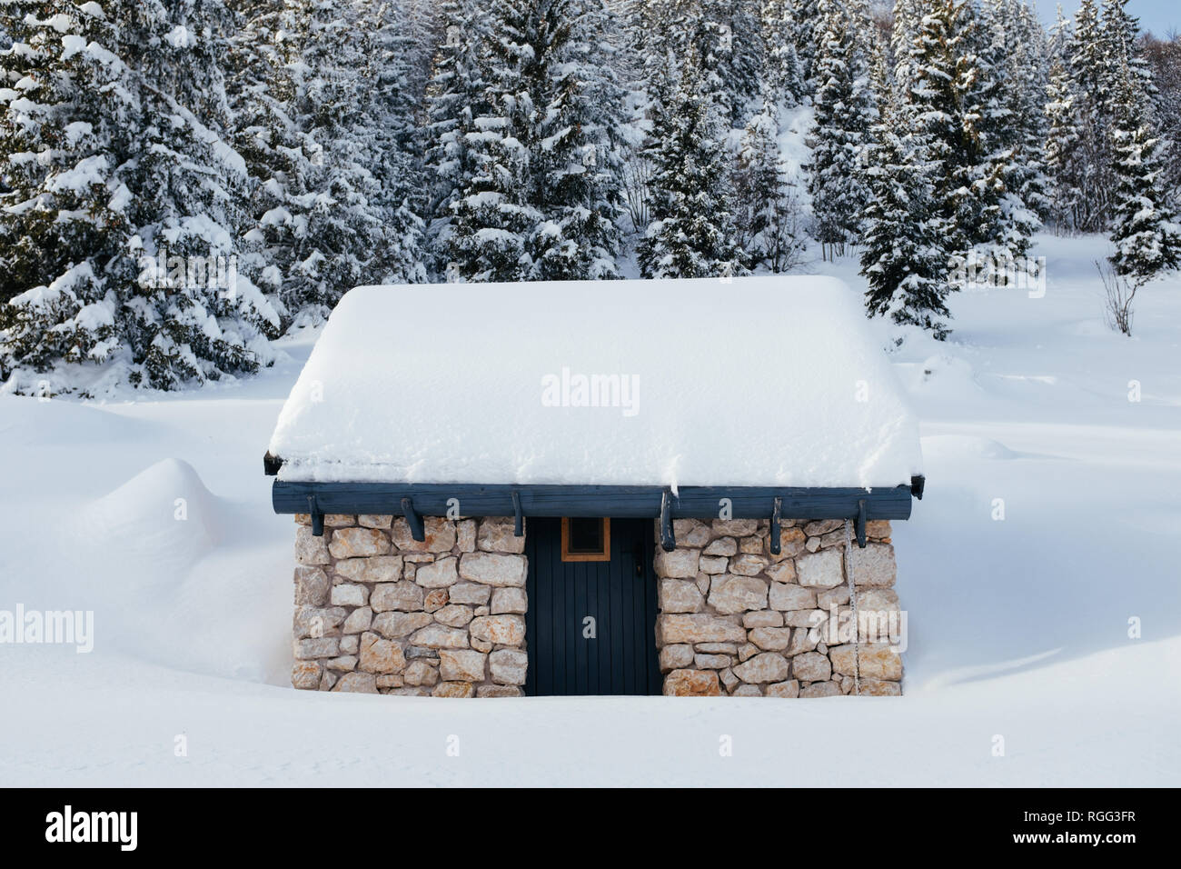 Small stone mountain hut covered with snow Stock Photo - Alamy