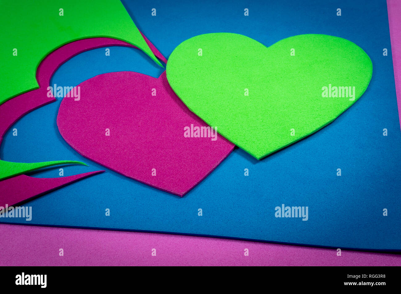 Hearts cut out of bright color foam sheets viewed in full frame ...