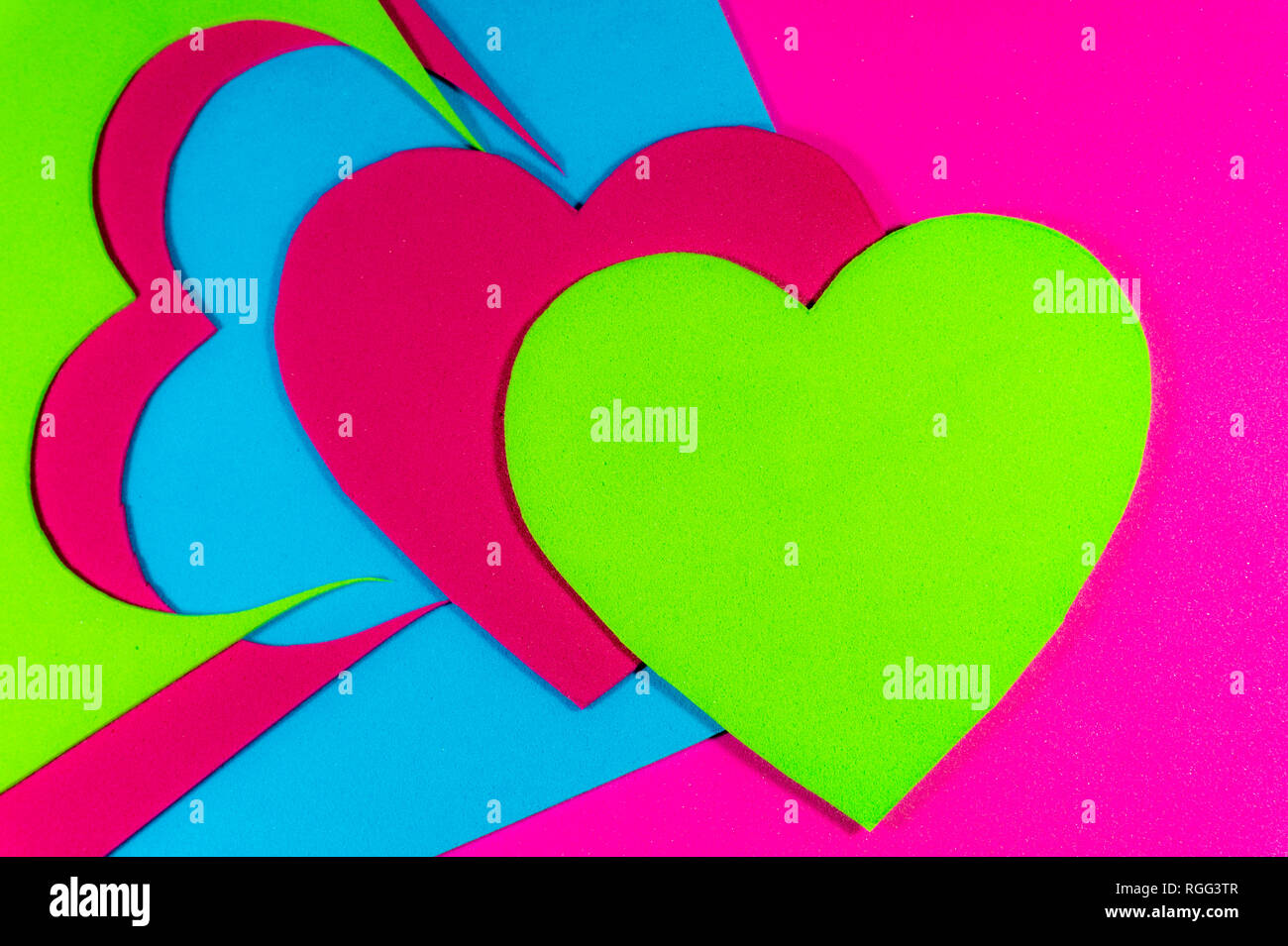 Hearts cut out of bright color foam sheets viewed in full frame ...