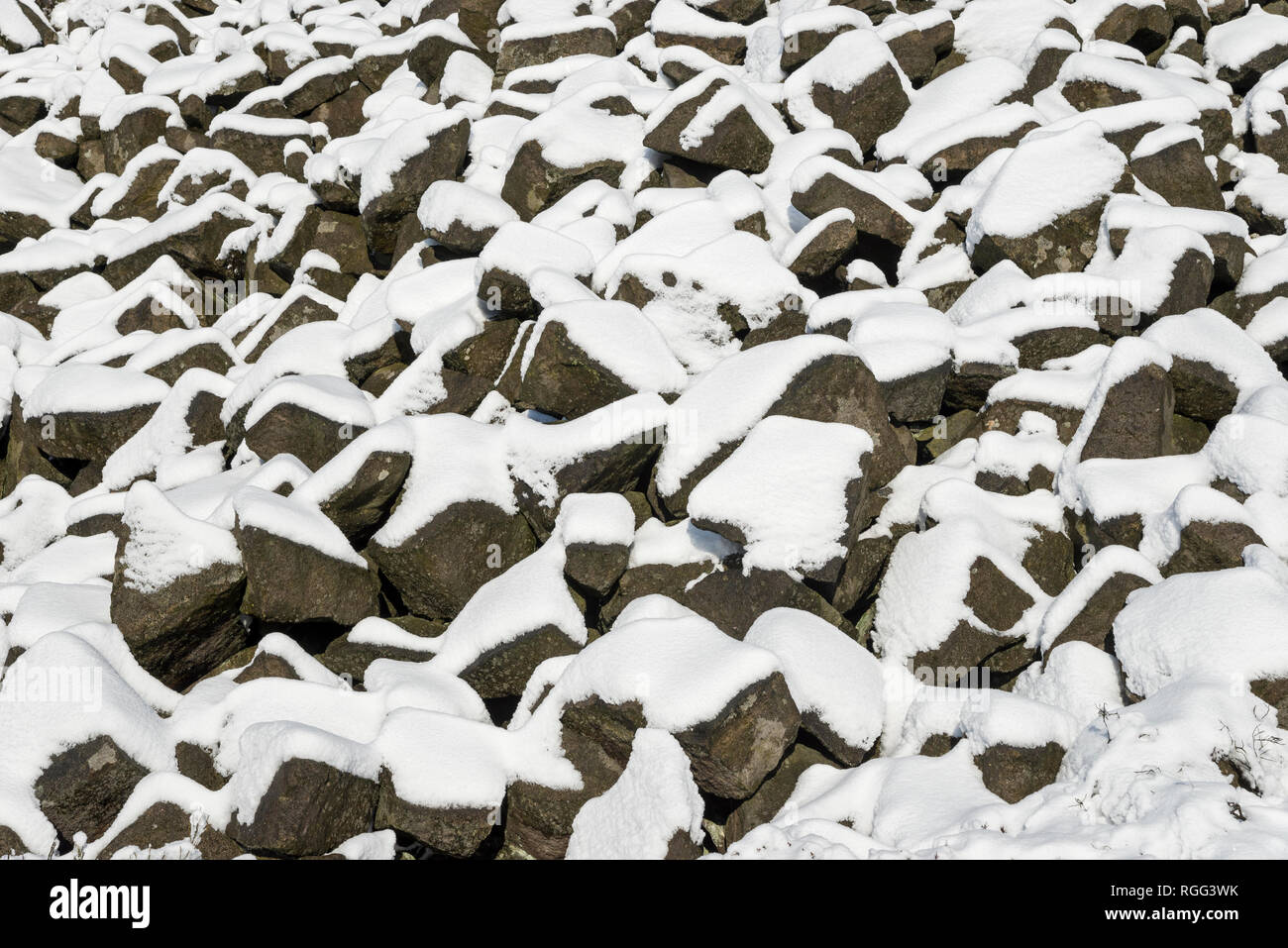 Snow on rocks at Knarr quarry near Tintwistle, Derbyshire, England ...