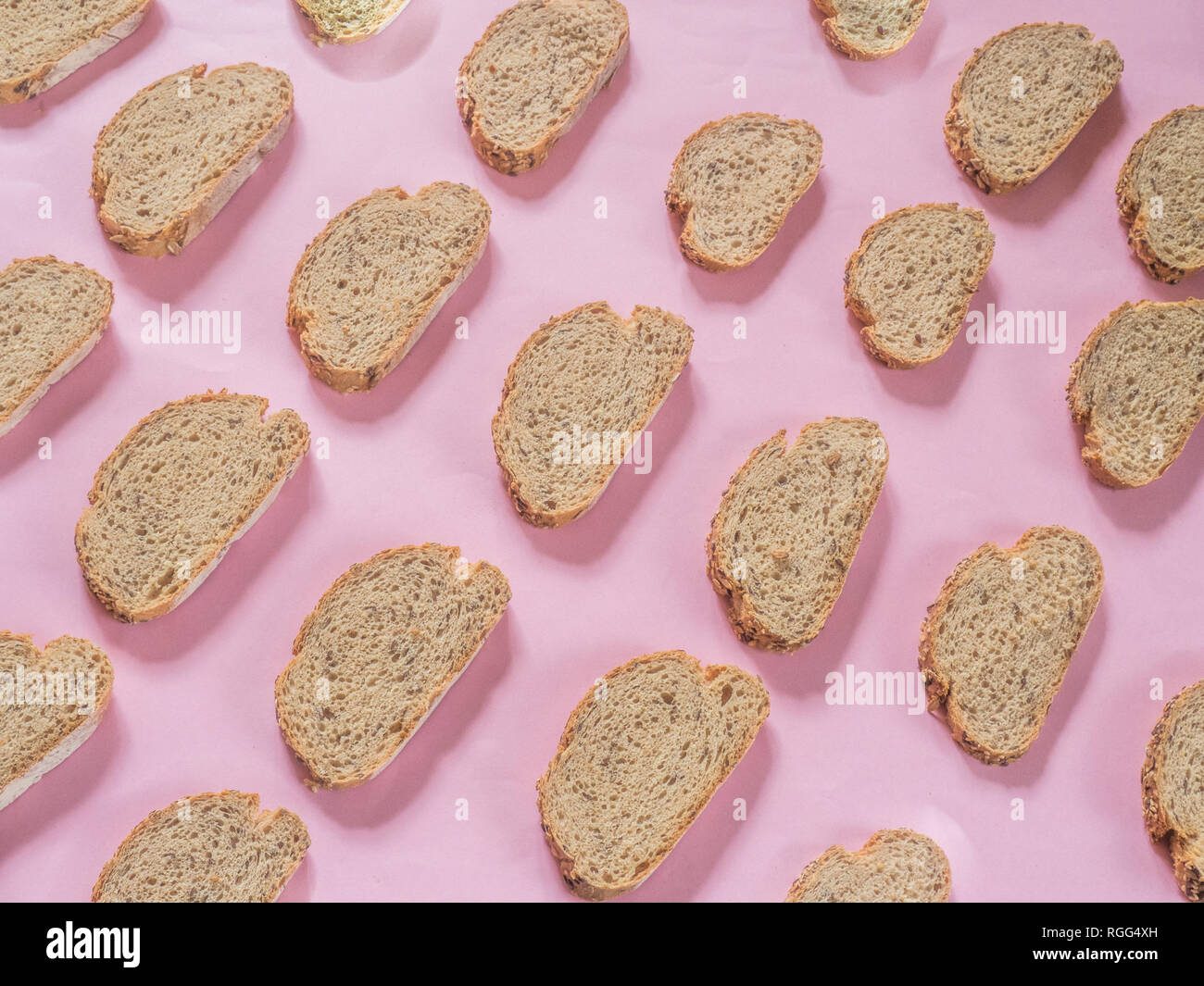 Bread with seeds pattern on pink background Stock Photo - Alamy