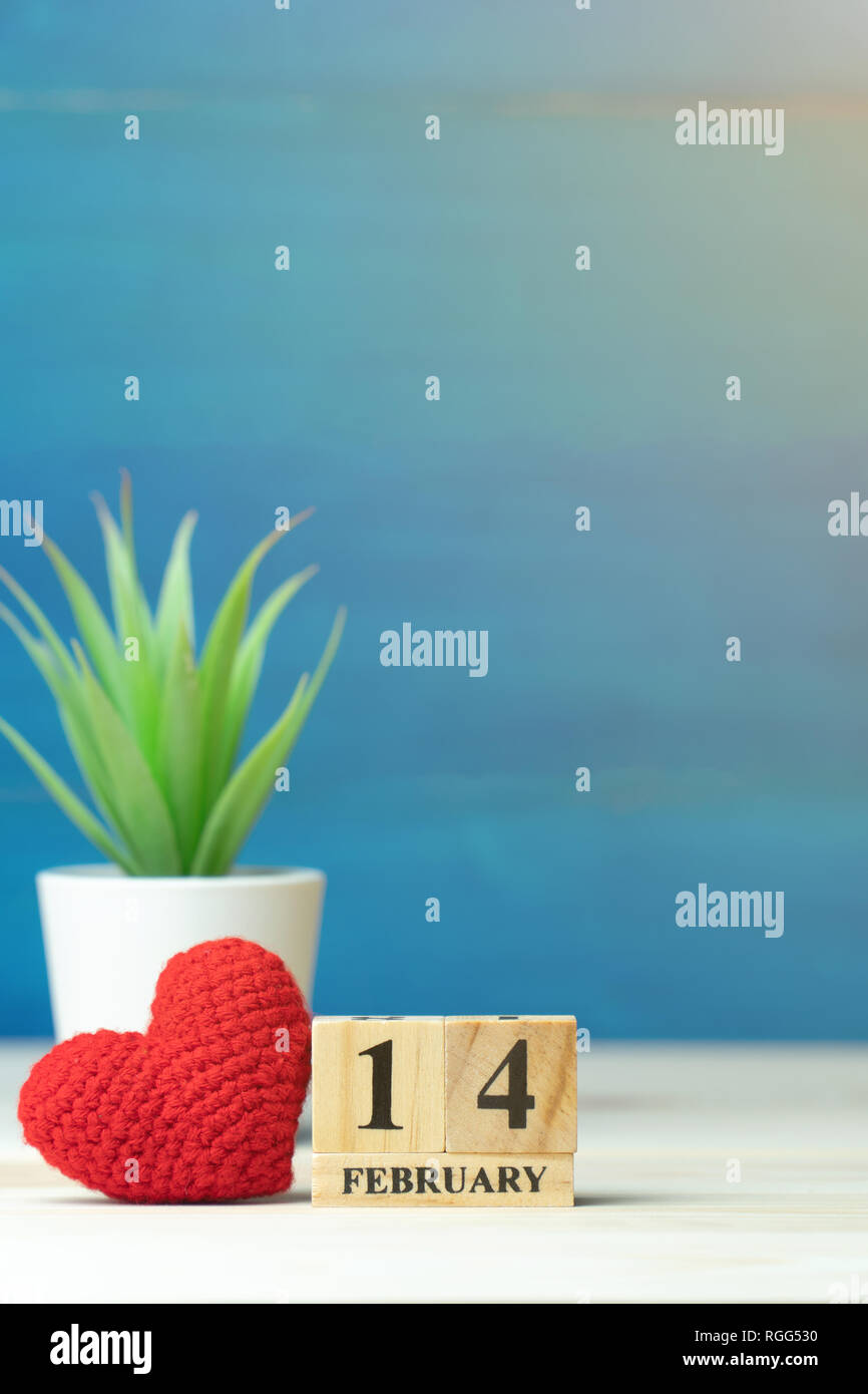 Valentines day concept. hand make yarn red heart beside wooden block ...