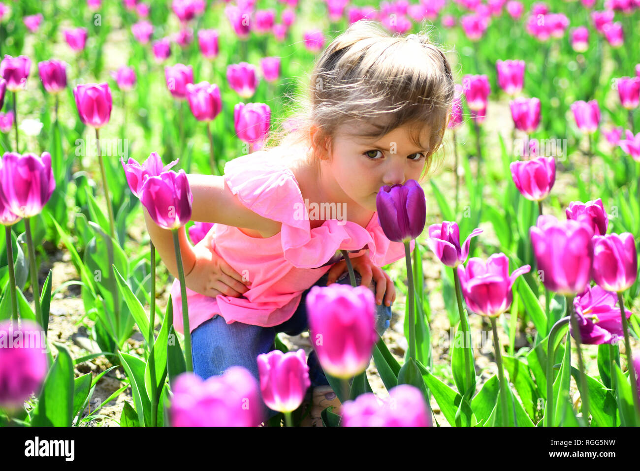 Pleasant time spending. Little girl in sunny spring. Small child ...