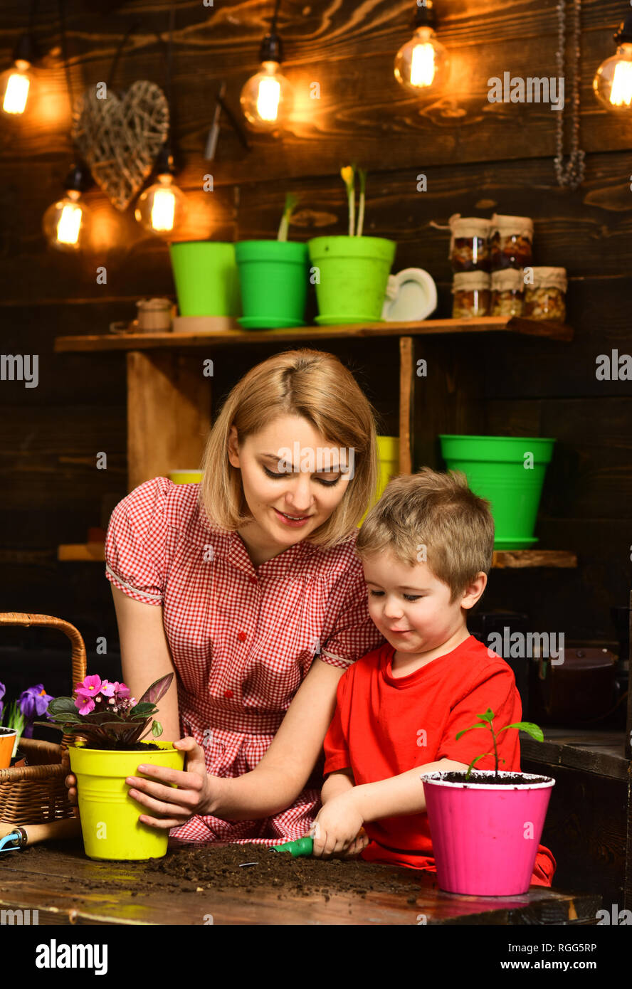 Nurture concept. Little child help mother nurture flower. Mother and ...